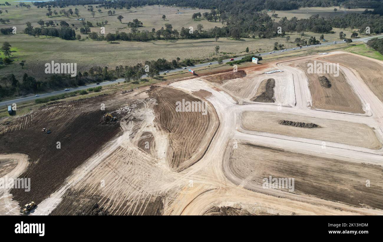 An aerial view of road construction surrounded by buildings and trees ...