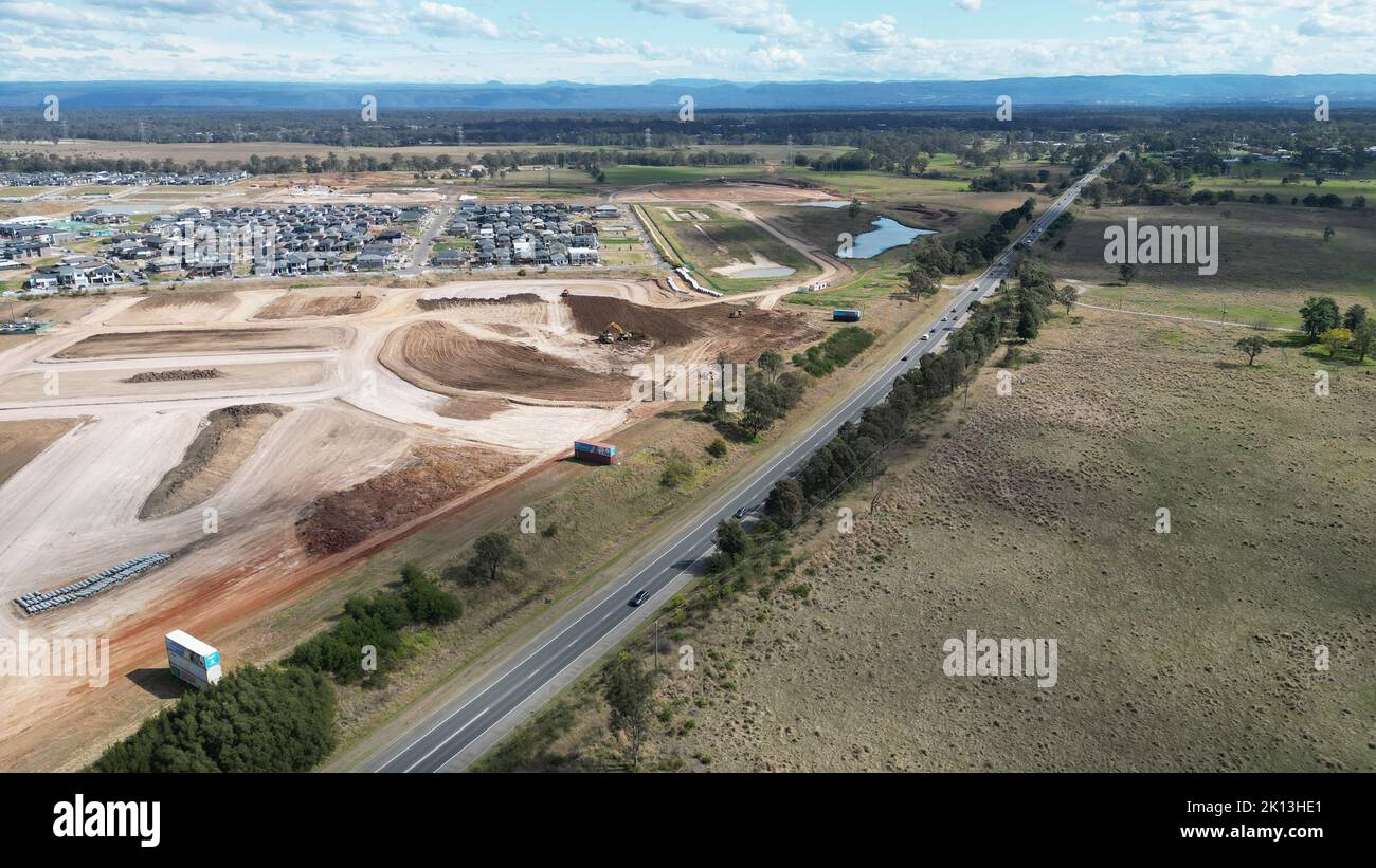 An aerial view of road construction surrounded by buildings and trees ...