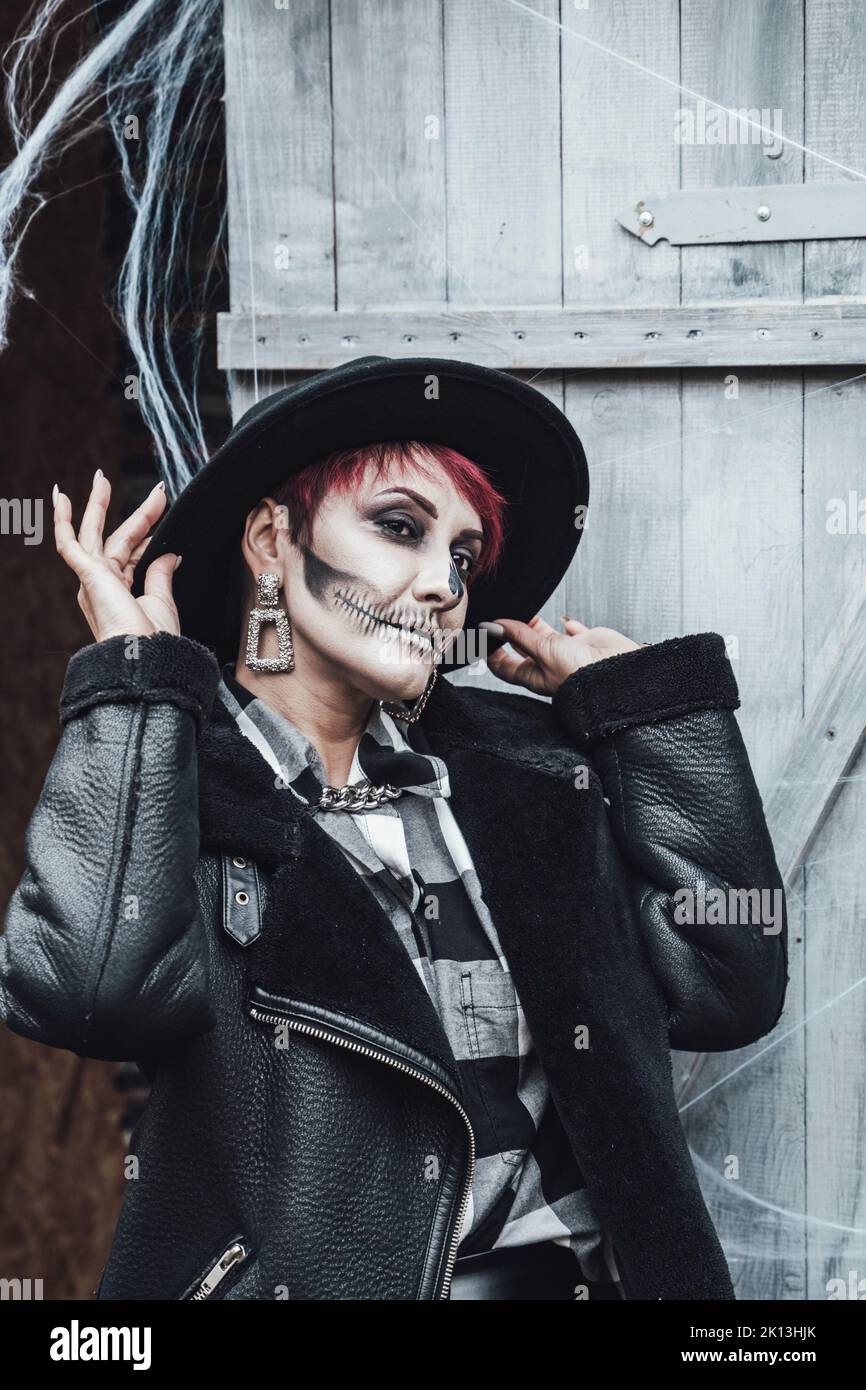 Scary woman, girl celebrating halloween.Terrifying black skull half ...