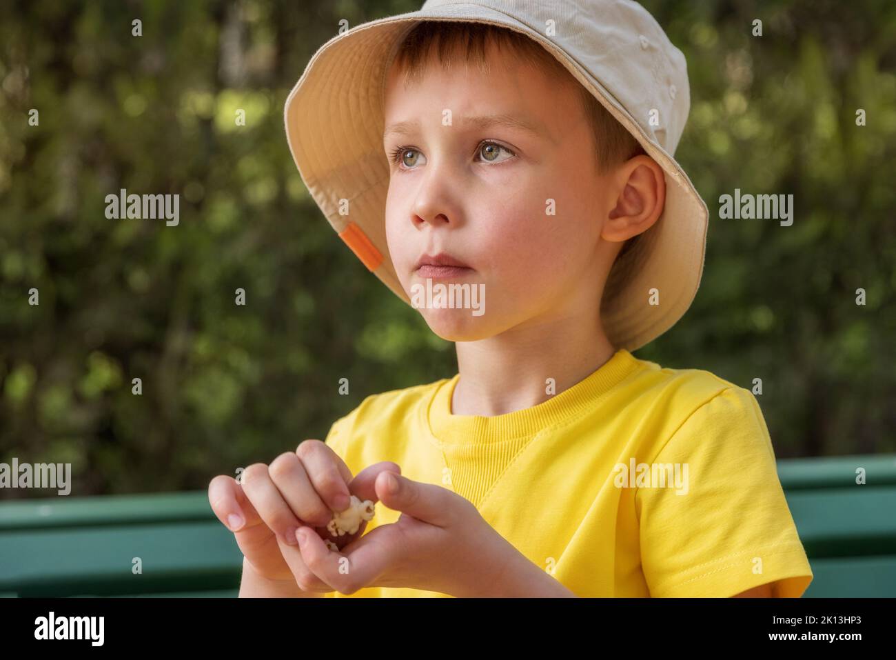 Close-up, portrait of boy who eats junk food, popcorn. Wrong eating ...