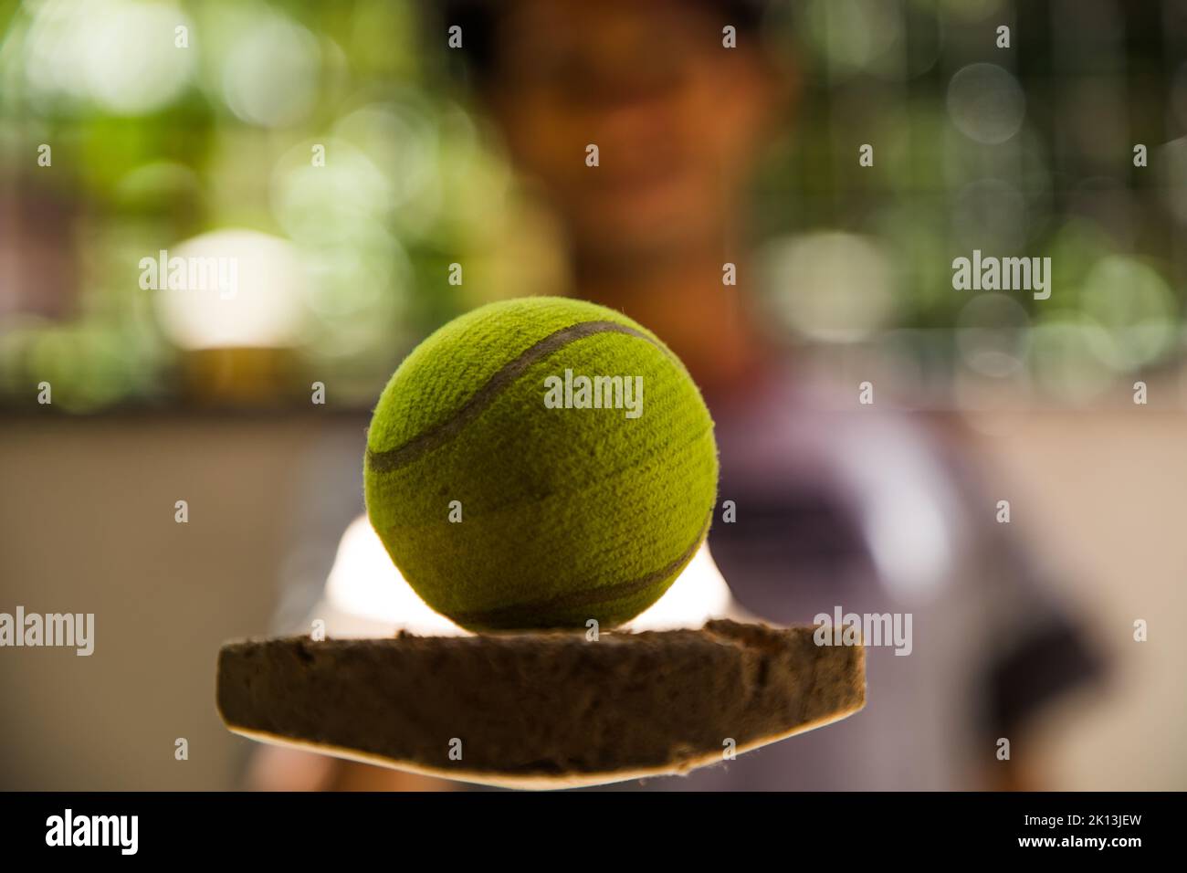 A closeup shot of a male sportsman balancing a small ball on a cricket ...