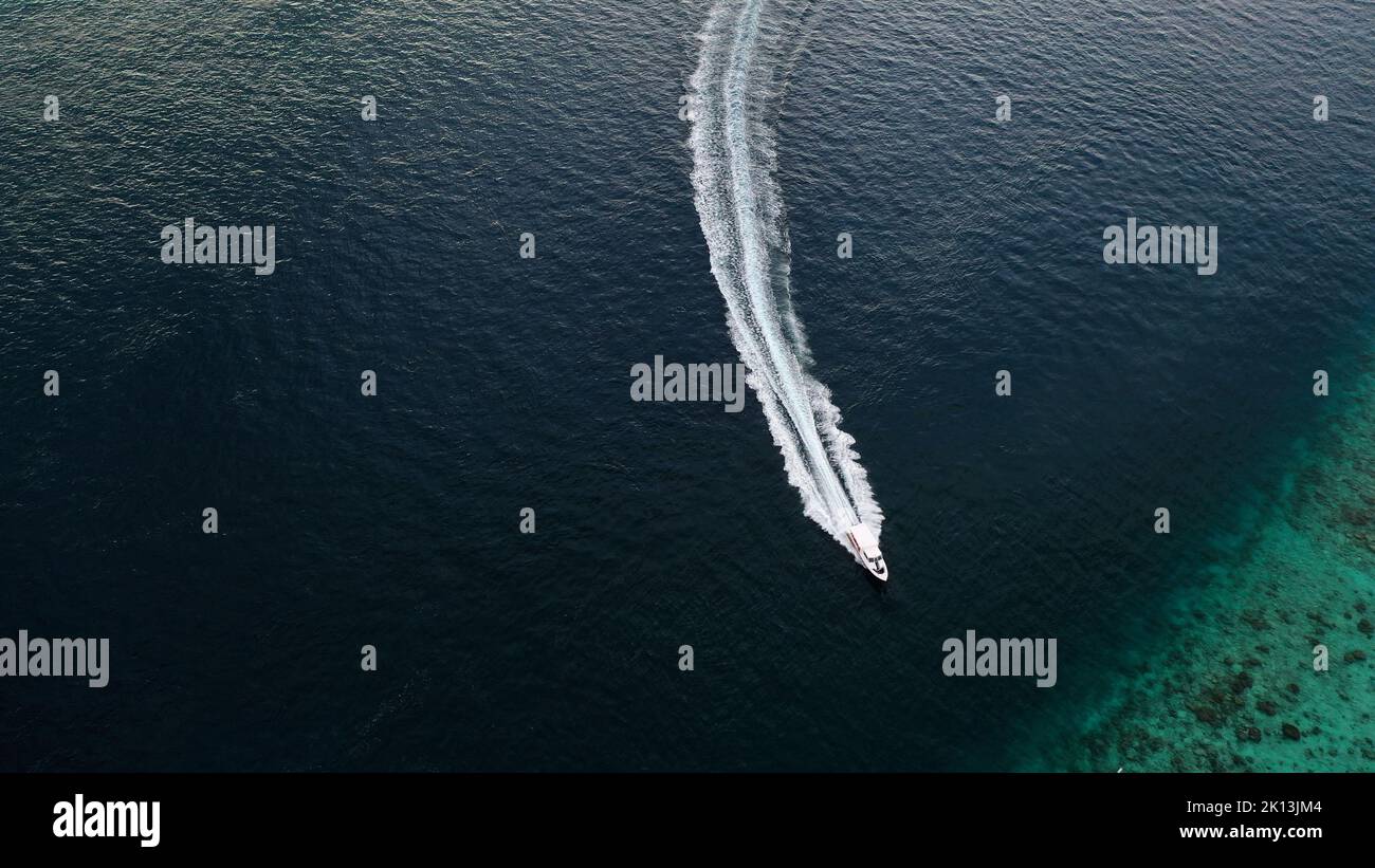 An aerial view of a yacht leaving a long trail in a sea Stock Photo - Alamy