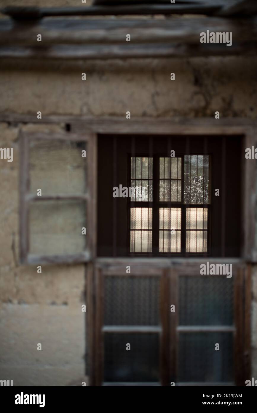 A beautiful shot of opened window of an old house with a view pf peach ...