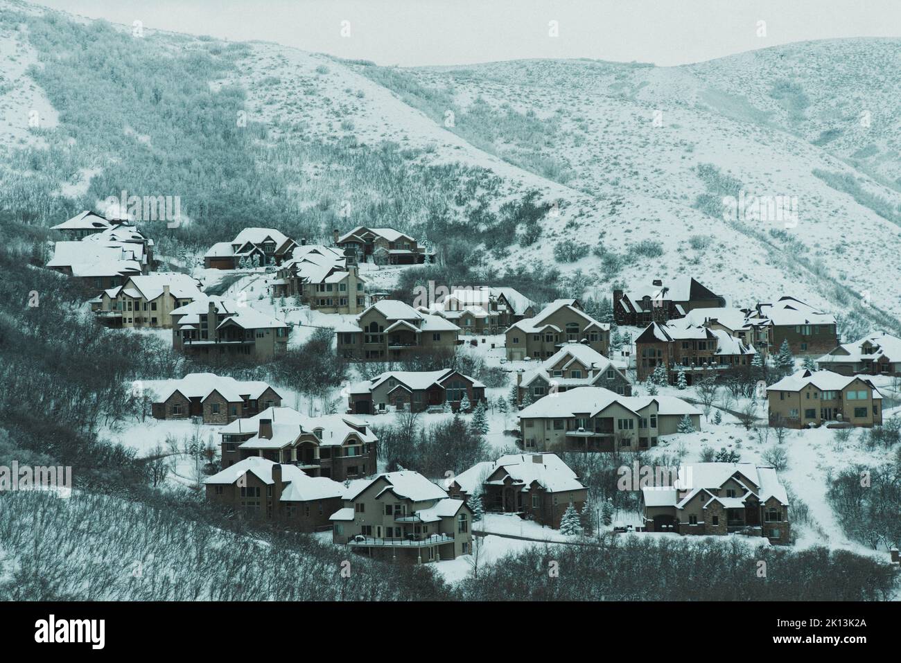 An aerial view of houses covered in snow in the mountains of Utah Stock ...