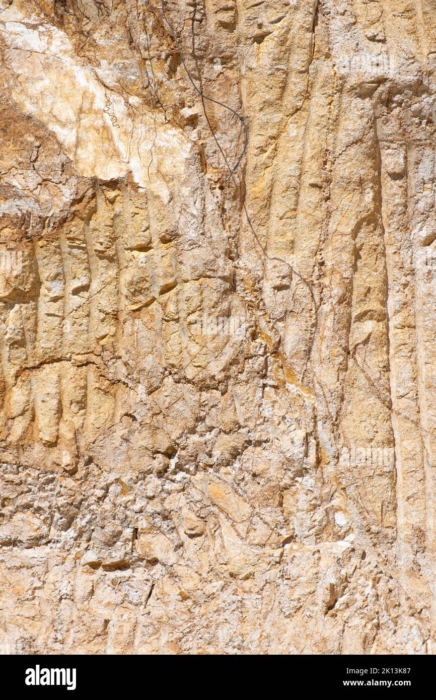 mechanic excavator teeth marks of an excavator on a quarry rock face ...