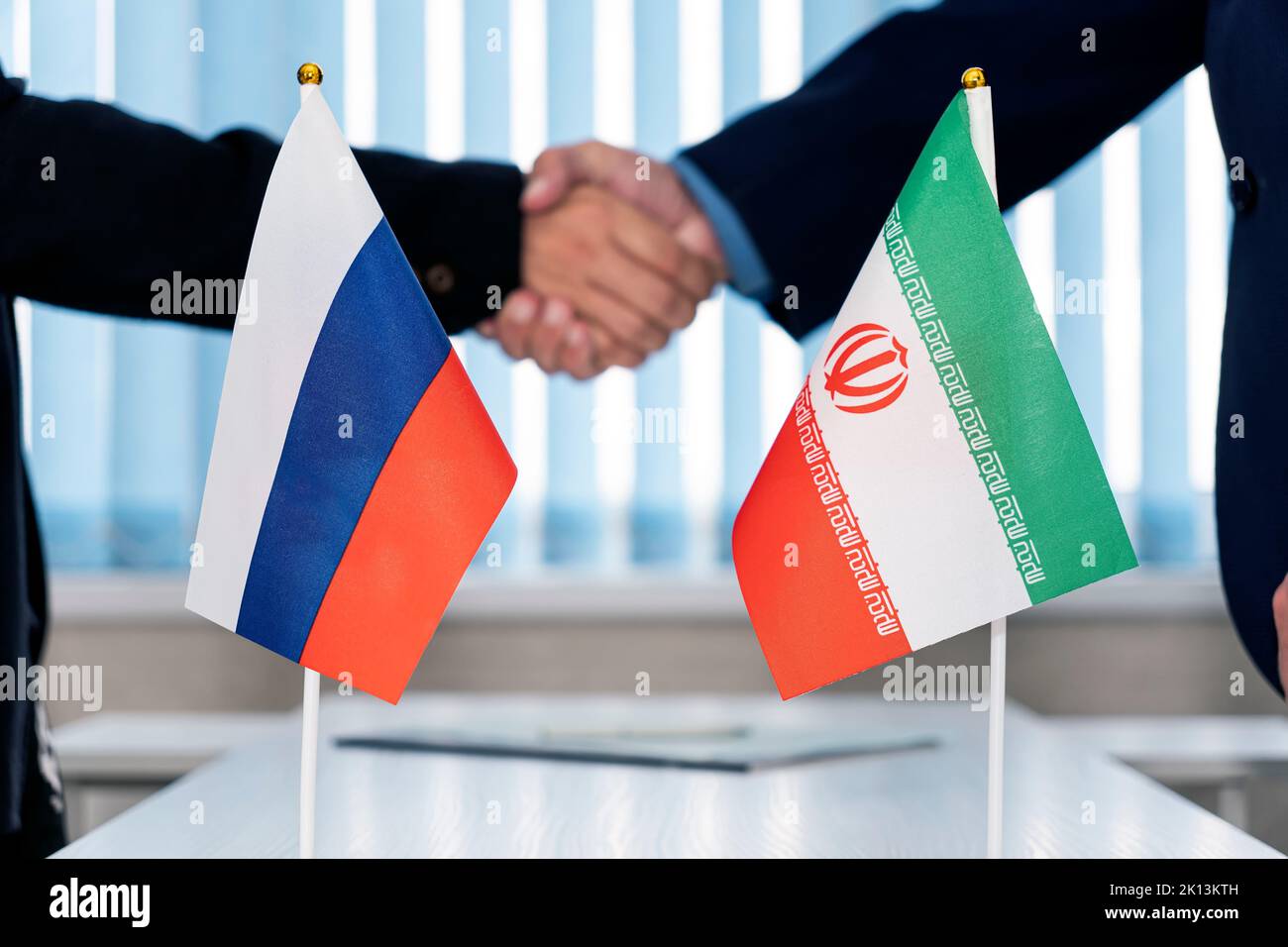 Political flags of russia and iran on table in international ...