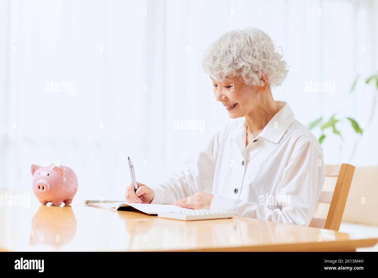 Japanese senior woman doing accounting at home Stock Photo - Alamy