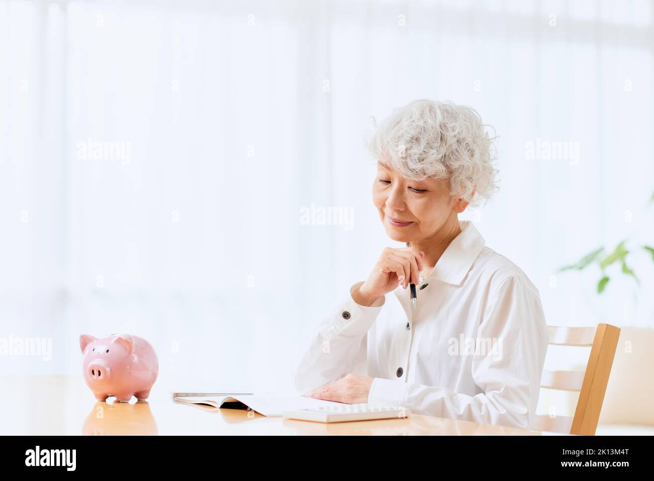 Japanese senior woman doing accounting at home Stock Photo - Alamy