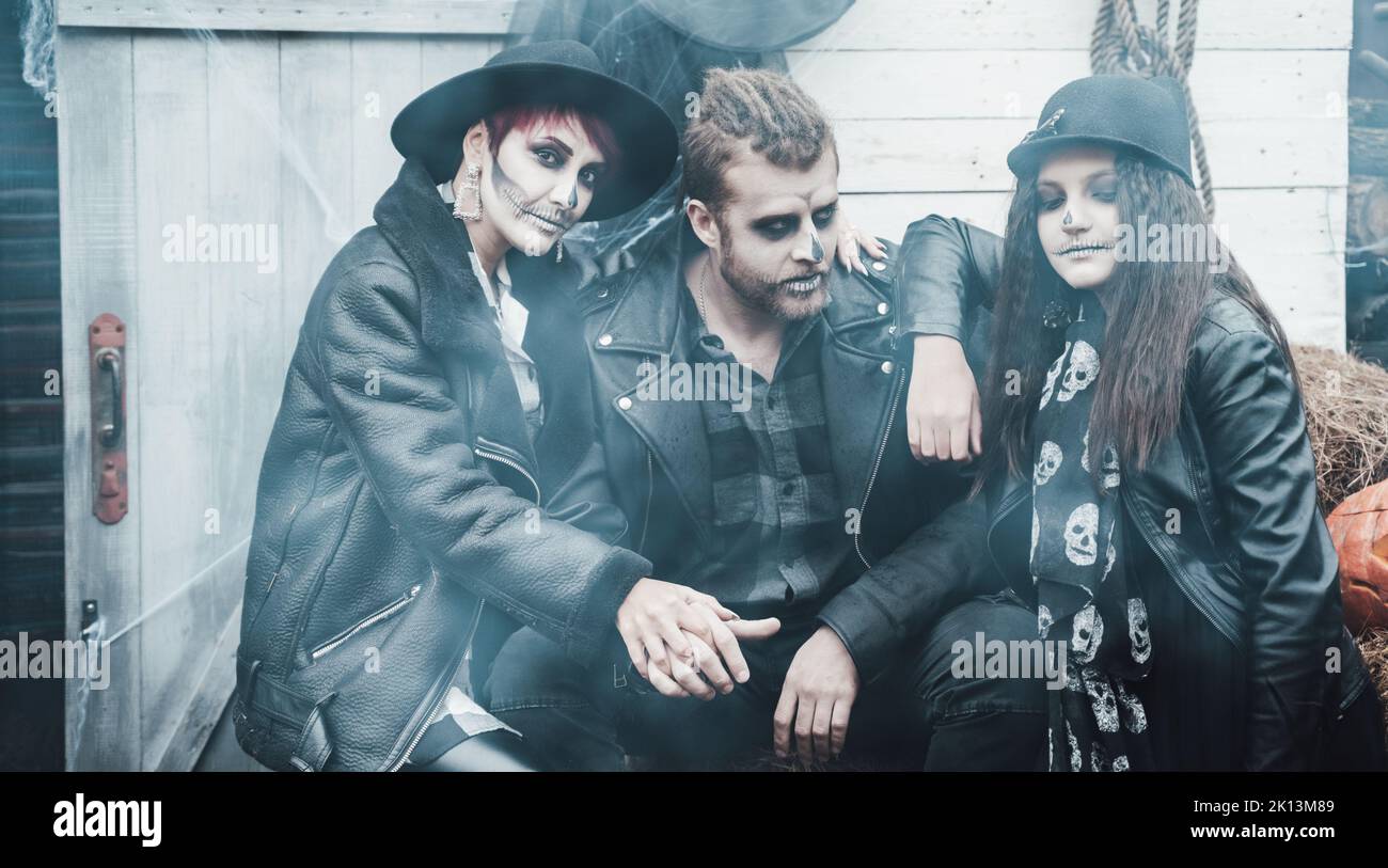 Scary family, mother, father, daughters celebrating halloween ...