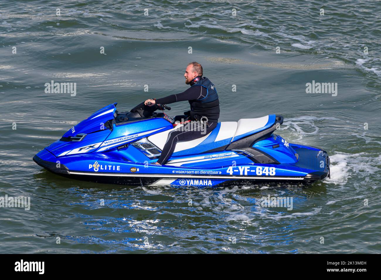 Rotterdam Sea Port police officer uses a jet ski to patrol the Port of ...