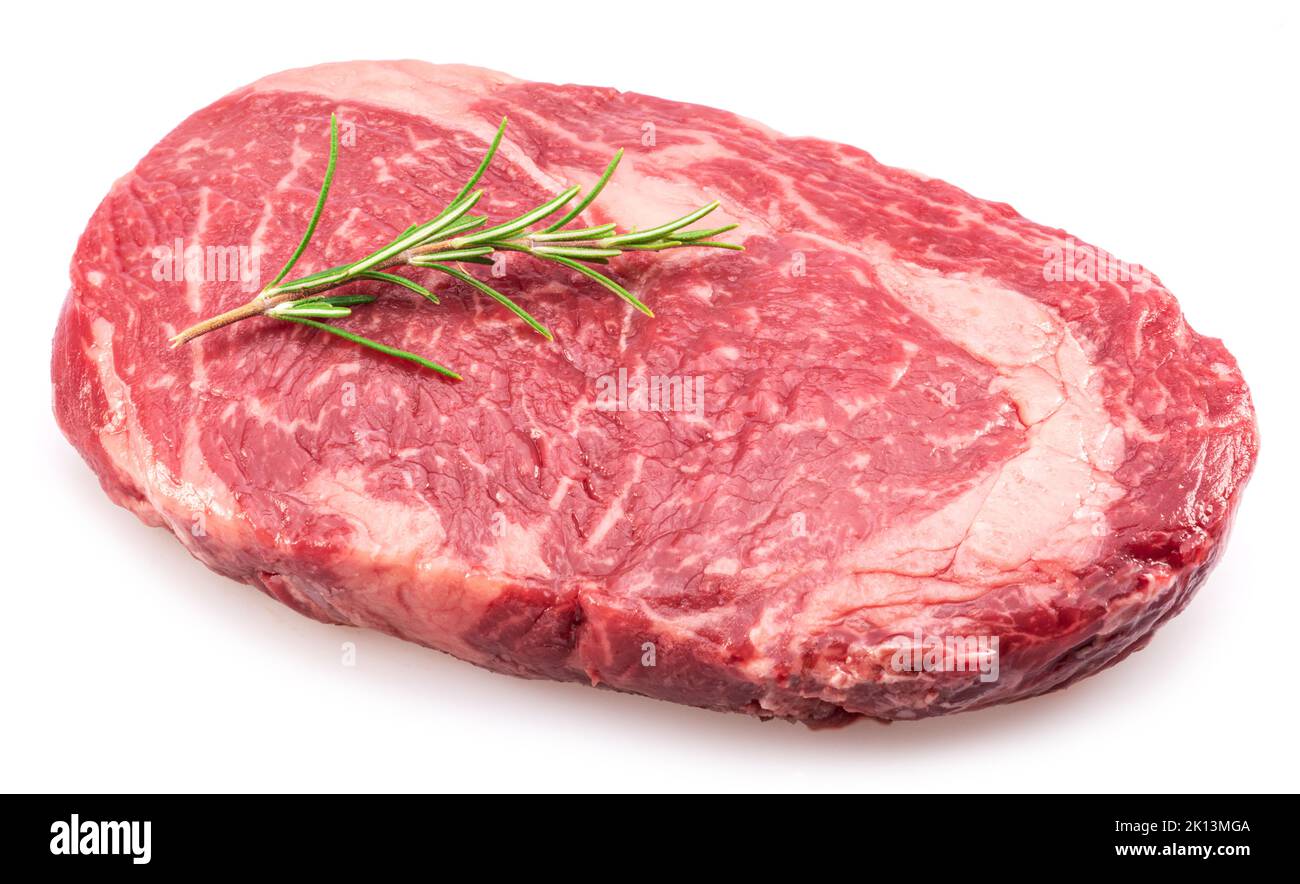 Raw ribeye steak with rosemary twig on it on white background. Top view ...