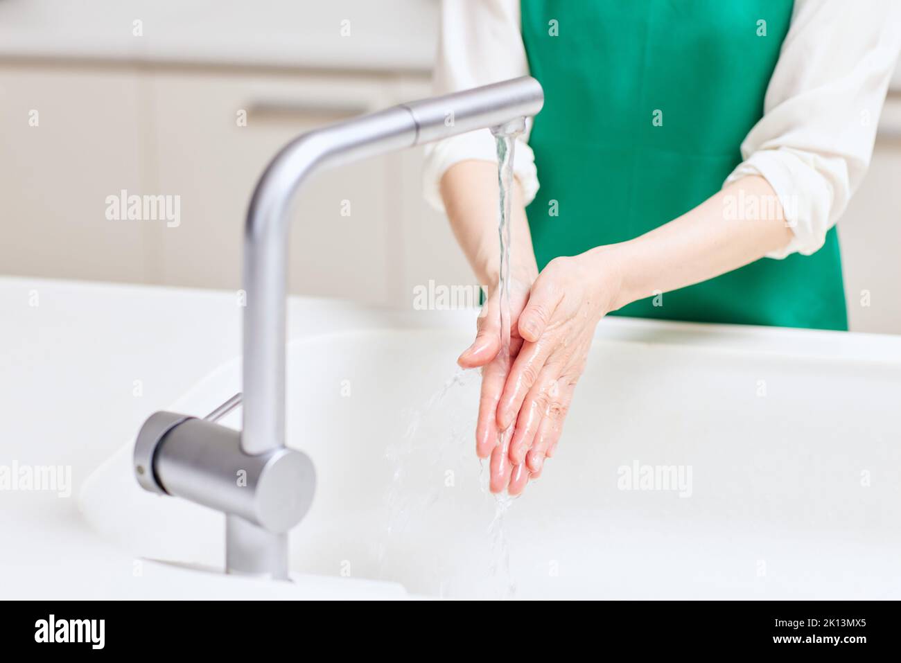 Senior woman washing hands hi-res stock photography and images - Alamy