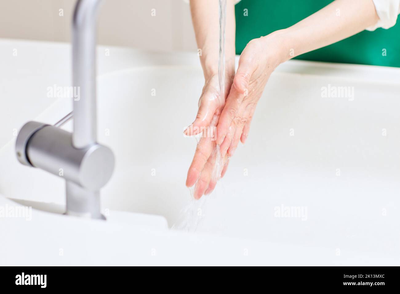 Senior woman washing hands hi-res stock photography and images - Alamy