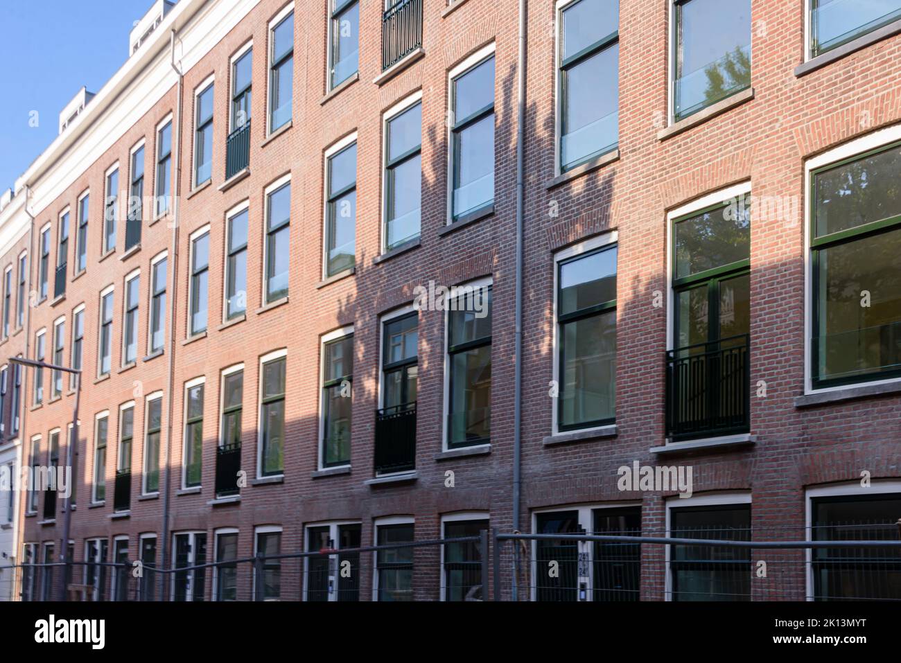 Newly built apartment block, still with site fencing around it ...