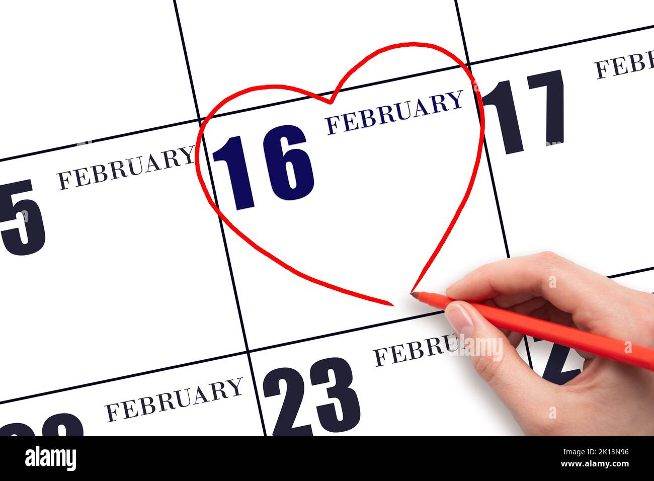 16th day of February. A woman's hand drawing a red heart shape on the ...
