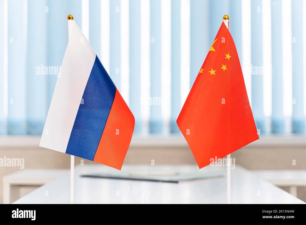 Political flags of russia and chinese on table in international ...