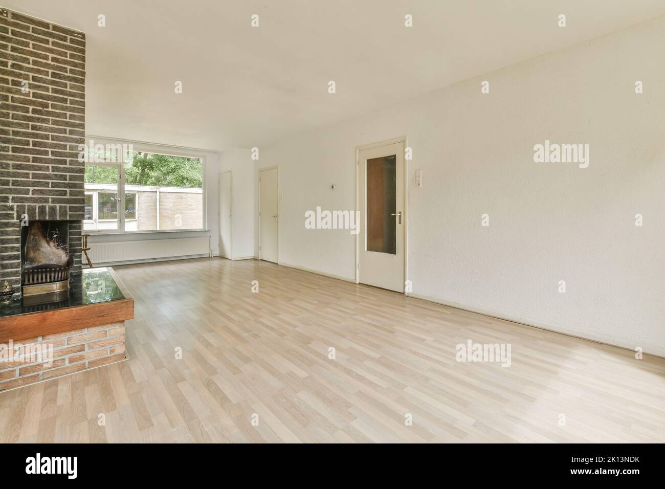 A cozy and spacious empty room with fireplace Stock Photo - Alamy