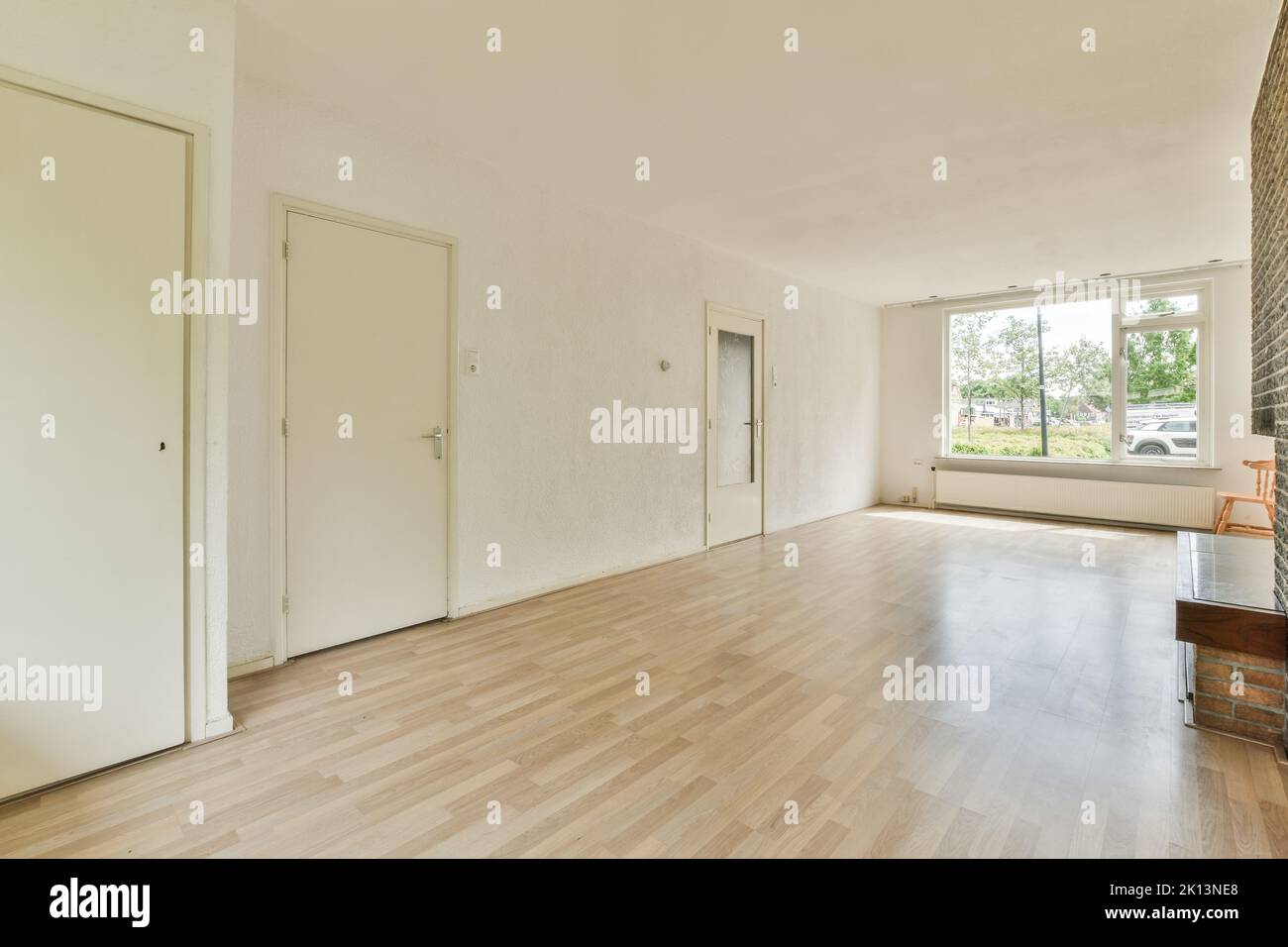 A cozy and spacious empty room with fireplace Stock Photo - Alamy
