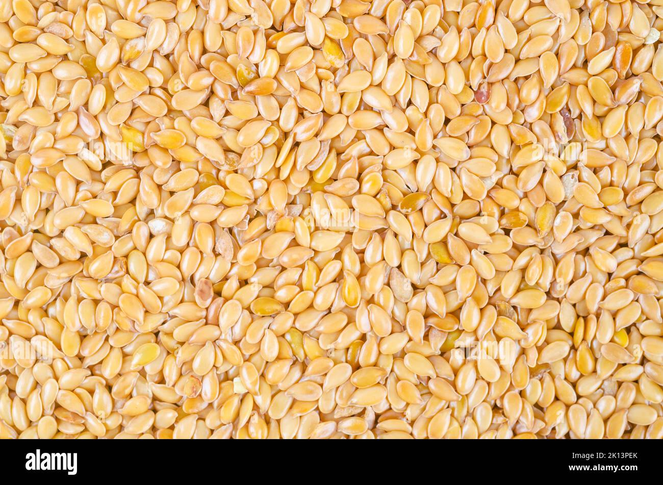 Gold flax seeds texture as background Stock Photo - Alamy