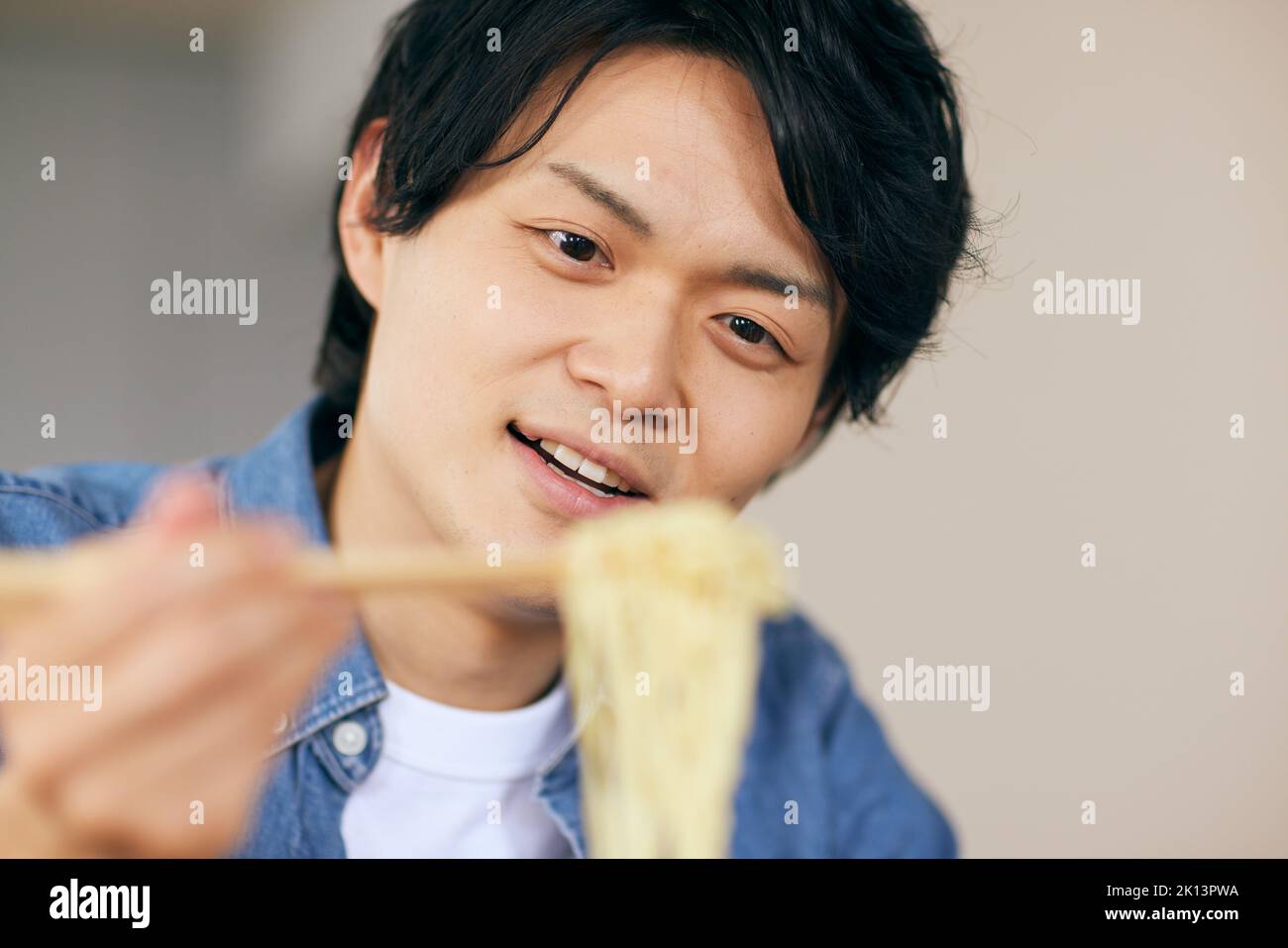 Young male eating ramen noodles hi-res stock photography and images - Alamy