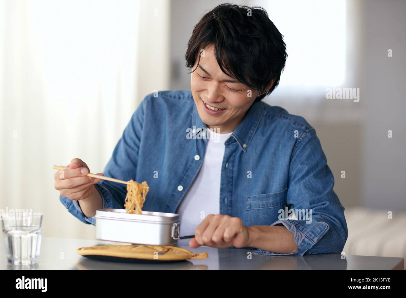 Young male eating ramen noodles hi-res stock photography and images - Alamy