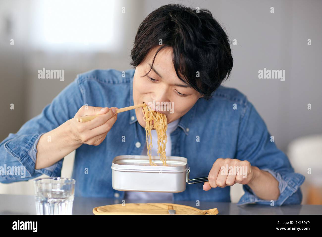 Person eating ramen chopsticks table hi-res stock photography and ...