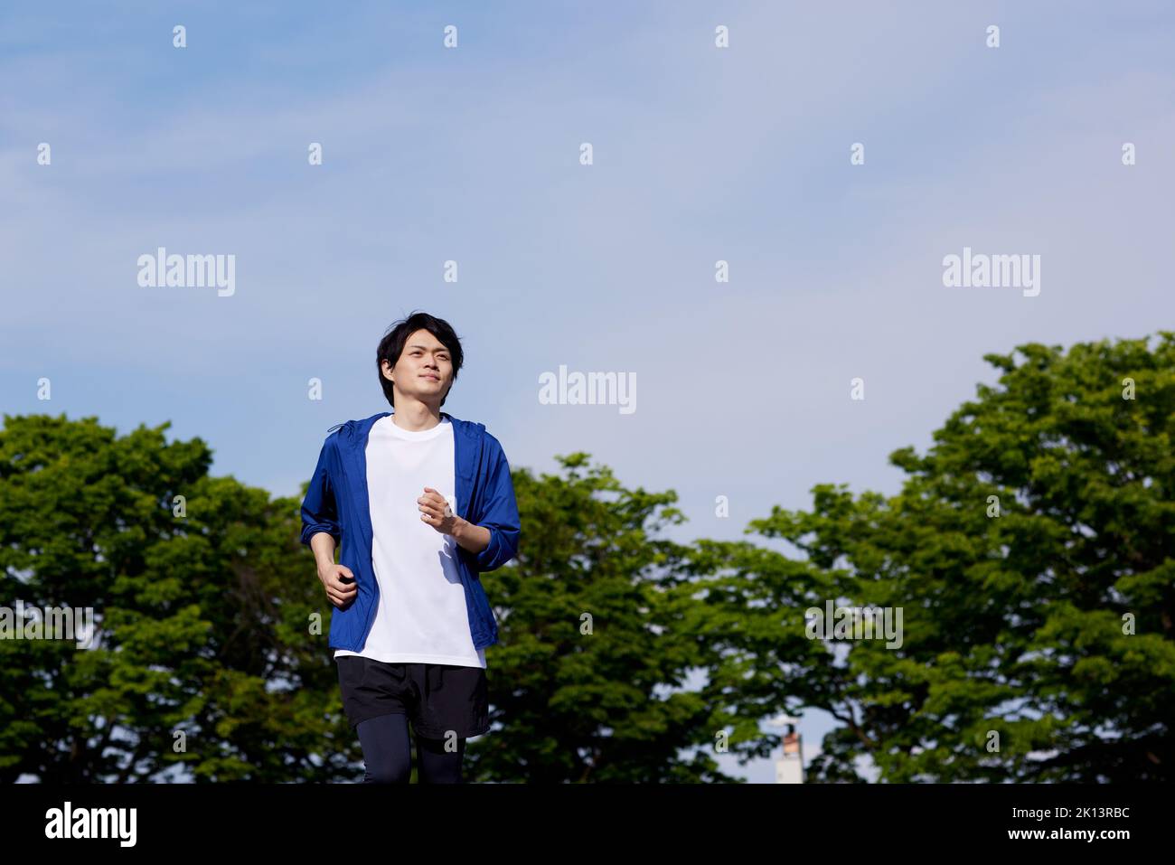 Japanese man running outside Stock Photo - Alamy