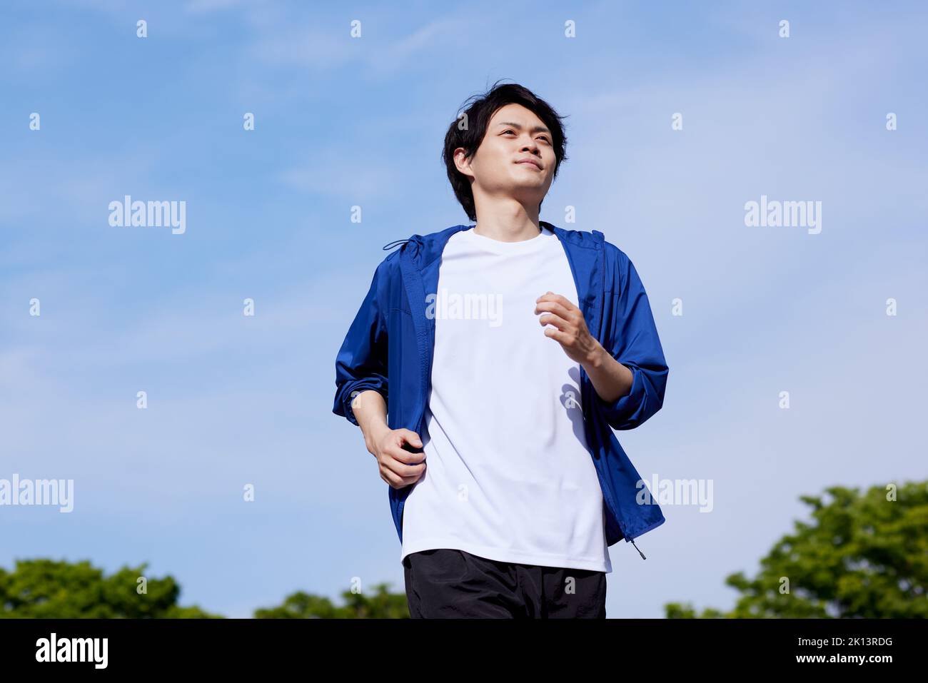 Japanese man running outside Stock Photo - Alamy