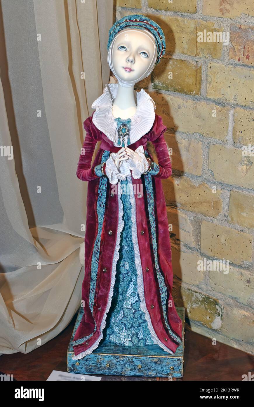 A collectible doll, a middle age matron in long dress, is on display at ...