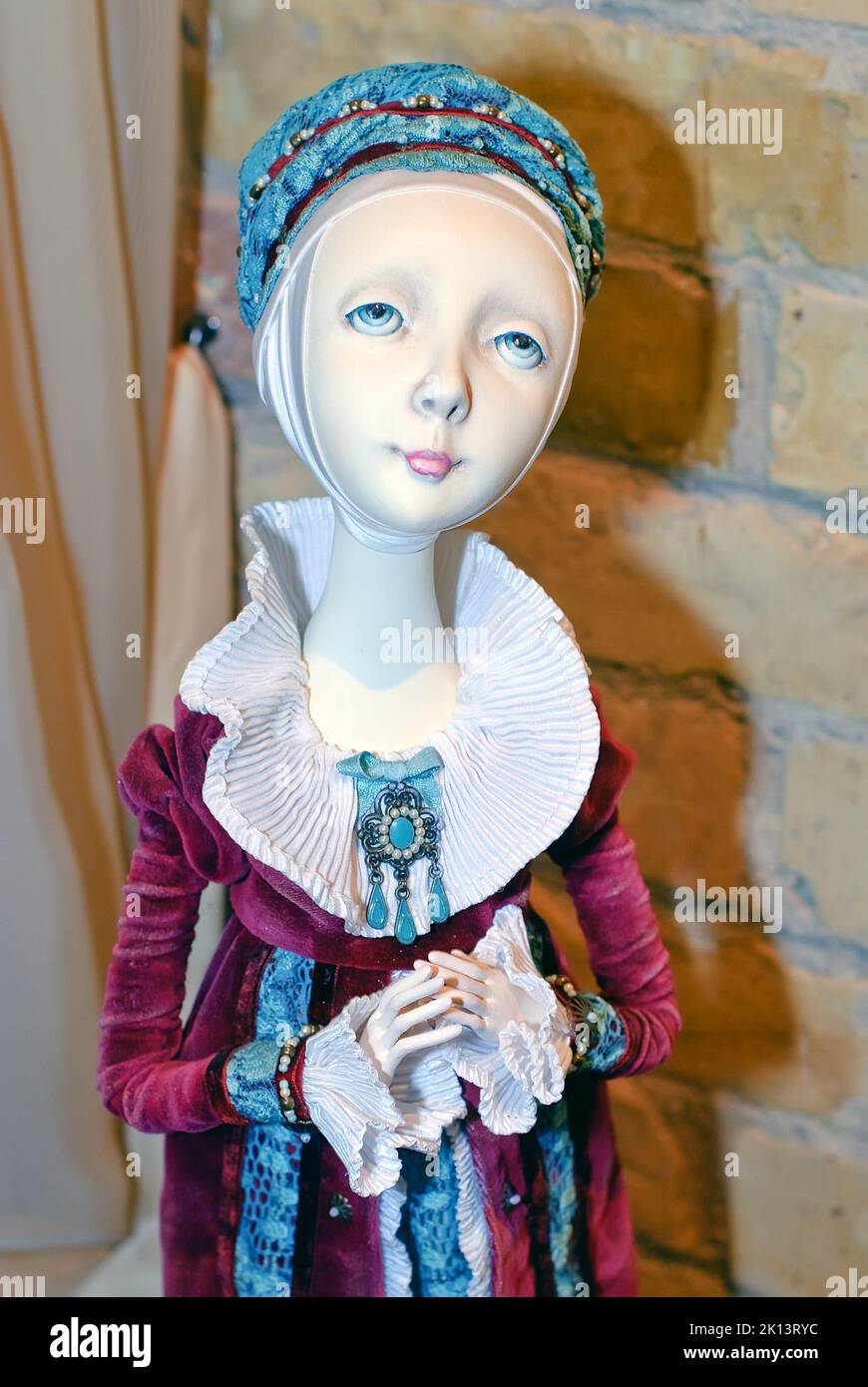 A collectible doll, a matron in long dress detailed, is on display at ...