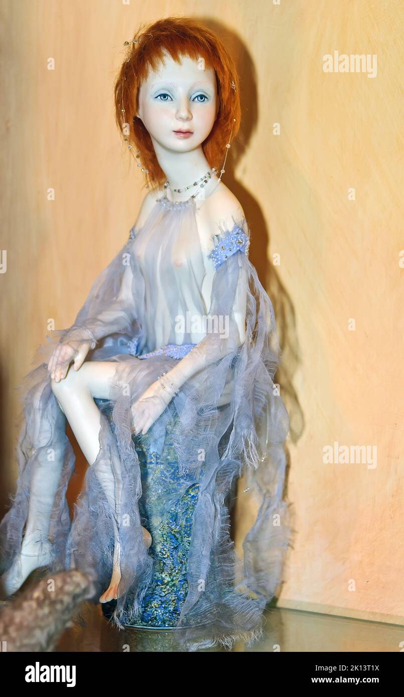 A collectible doll, red-haired girl in light cape, is on display at the ...