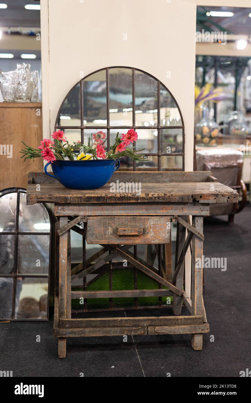 Antique Wooden Table with a Drawer and Large Blue Vase with Pink ...