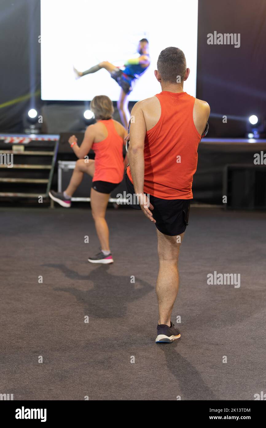 Fitness Workout in Gym: People doing Exercises in Class with Music and ...