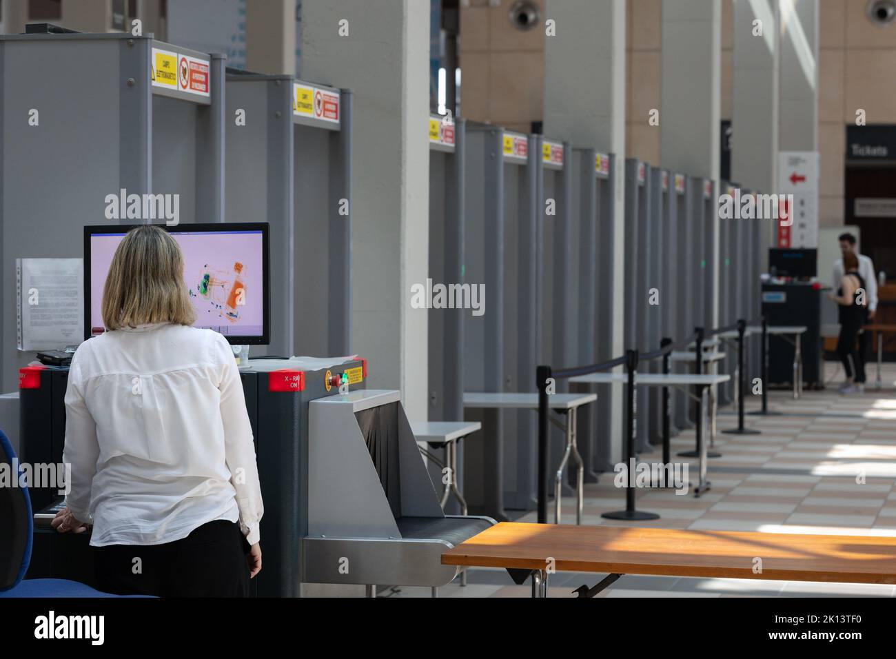 Security personnel checking bags and backpacks x-rayed at the access ...
