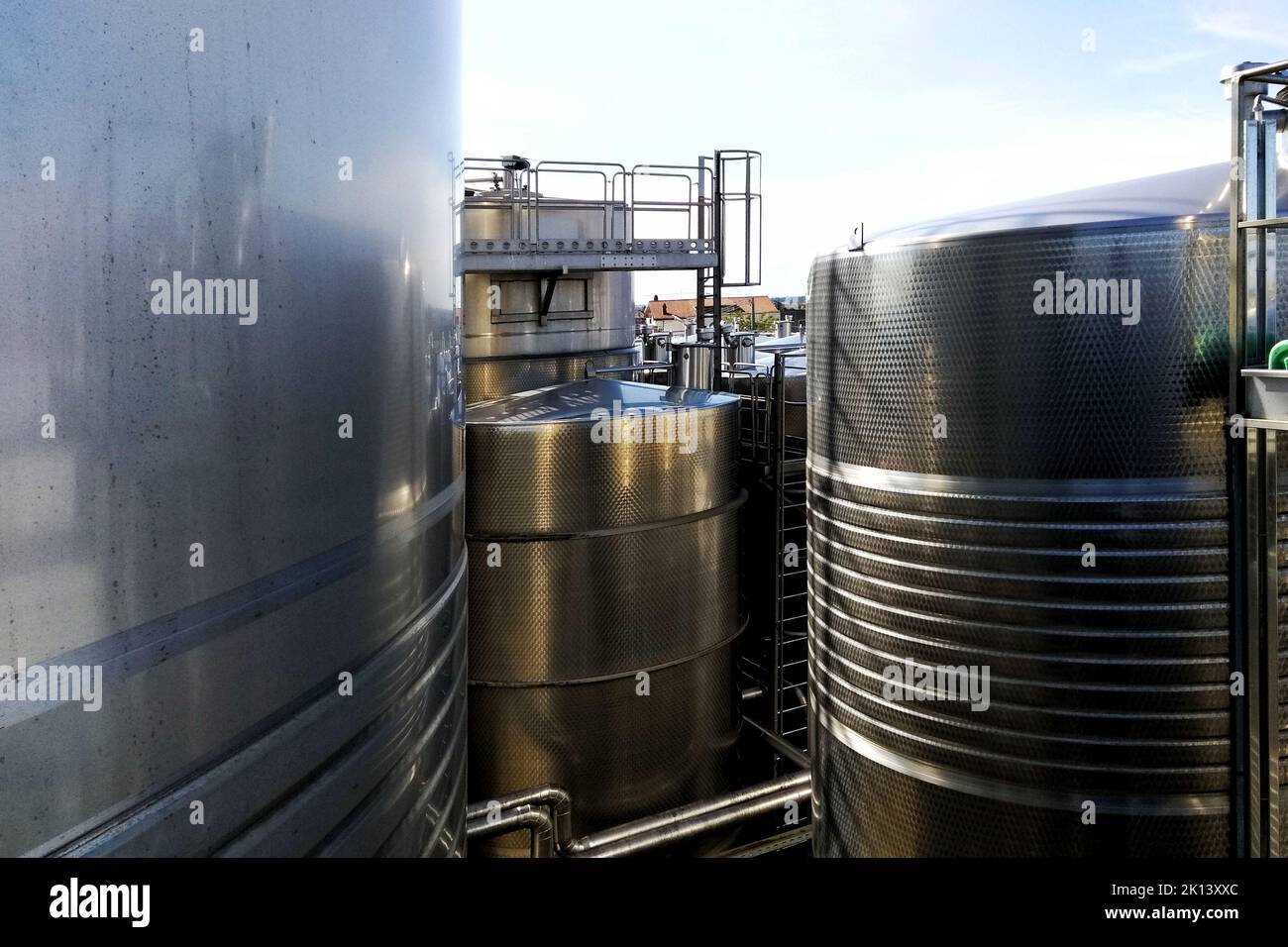 Huge stainless steel tanks in an industrial center Stock Photo - Alamy