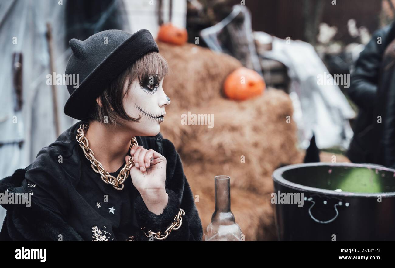 Beautiful scary little girl celebrating halloween. Terrifying black ...