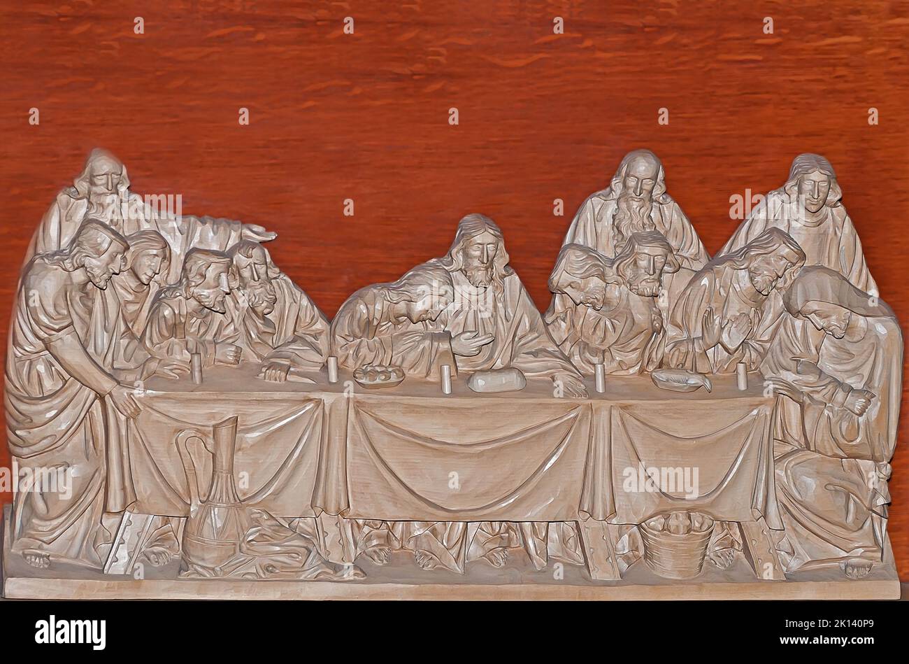 Religious relief of The Last Supper made of polish wood on red ...