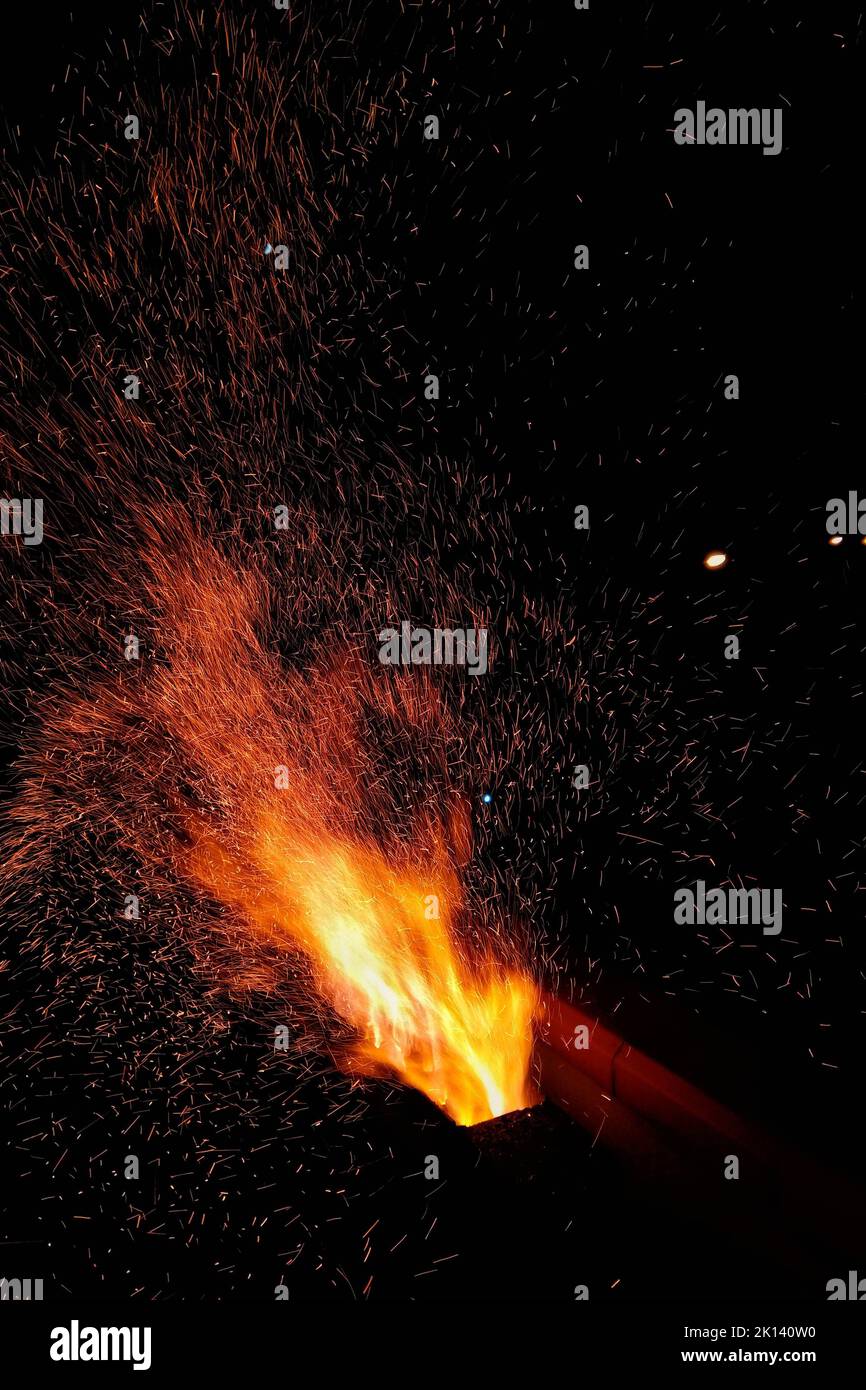 A vertical shot of fire sparks at night Stock Photo - Alamy