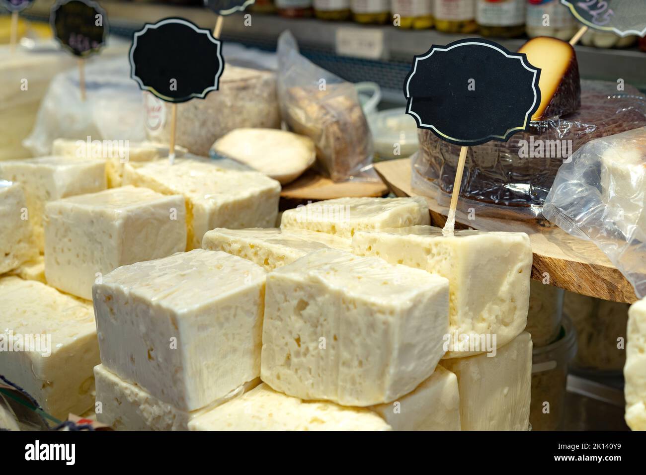 Assortment of appetizer cheese at food shop stand Stock Photo - Alamy