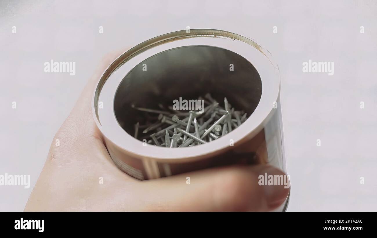 Bunch of small metal nails in a jar Stock Photo - Alamy