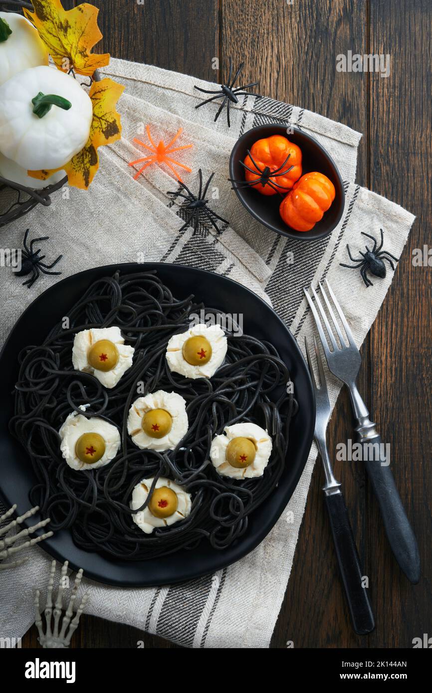 Halloween party Italian black pasta decorated horror olives like eyes ...