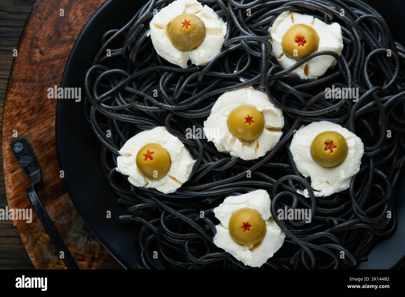 Halloween party Italian black pasta decorated horror olives like eyes ...