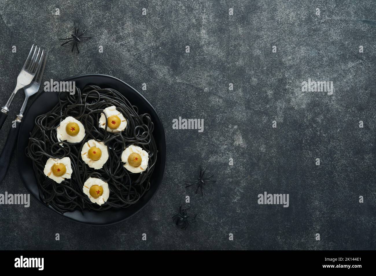 Halloween party Italian black pasta decorated horror olives like eyes ...