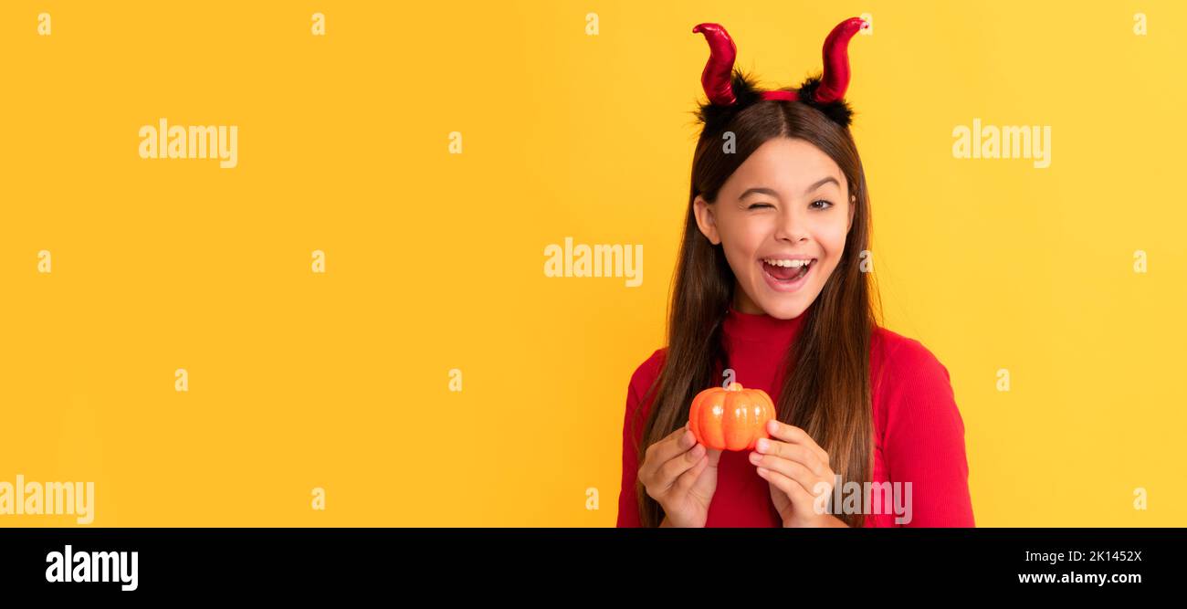 happy halloween. devil kid with pumpkin. trick or treat. teen girl on ...