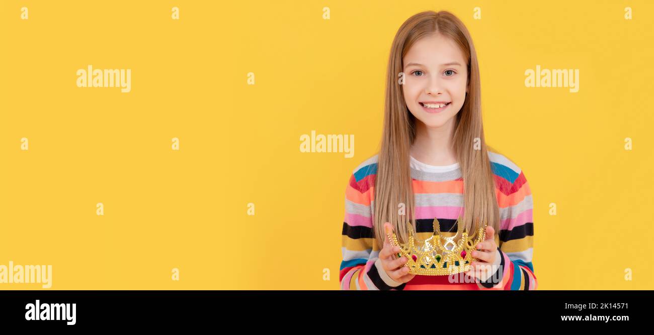 positive teen child hold queen crown on yellow background. Child queen ...