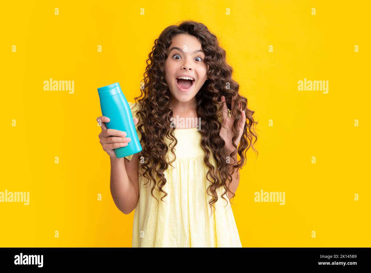 Child teen girl with shampoos conditioners and shower gel. Long hair ...