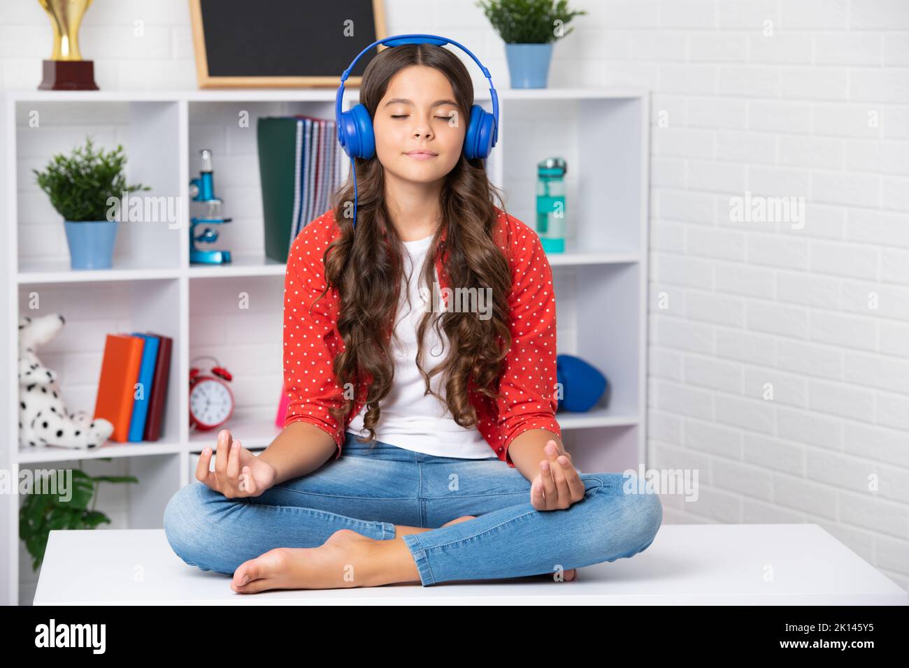 Mindfulness, meditation and relaxation concept. Teen girl with wireless ...