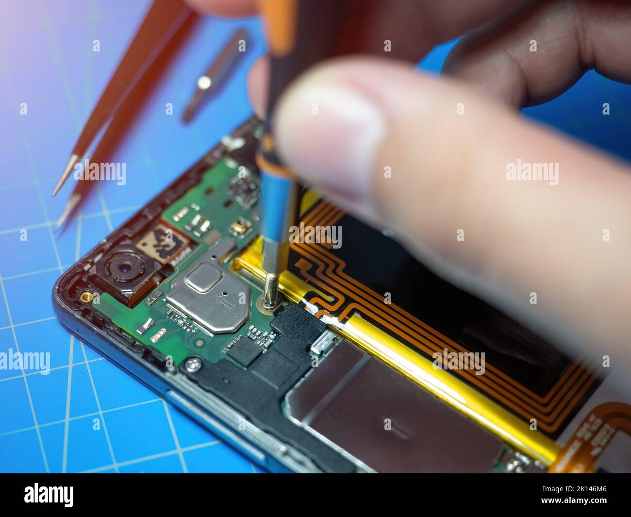 Smartphone technician repairing the motherboard of a smartphone on ...
