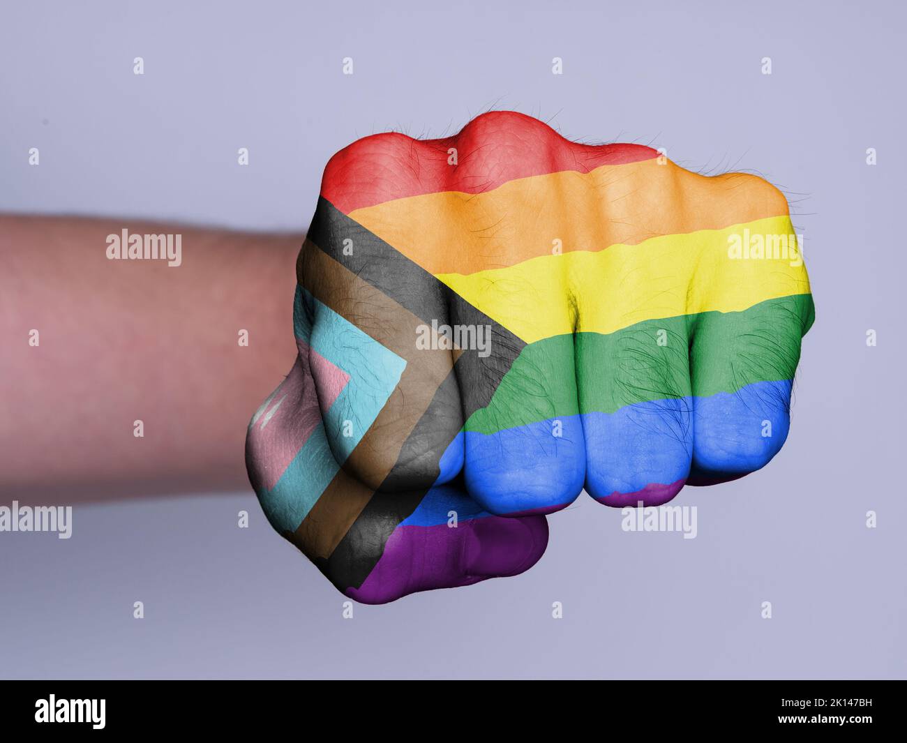 Male fist isolated on a white background - Progress LGBTQ rainbow flag ...