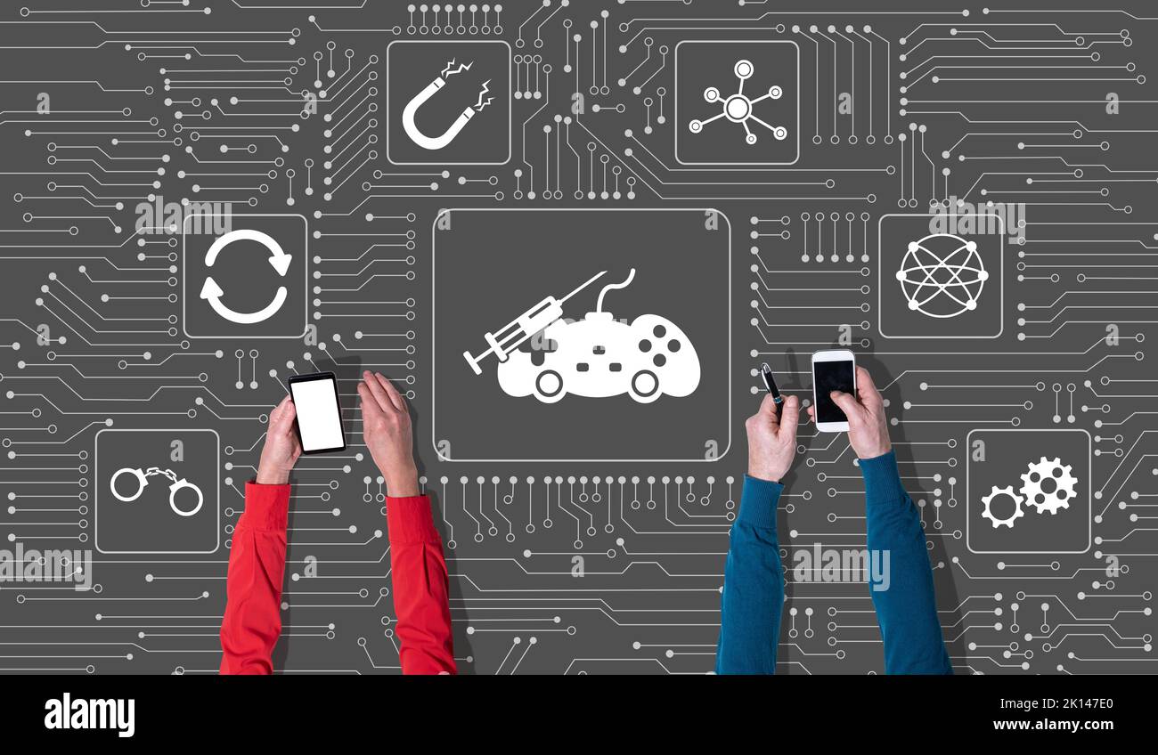 Top view of hands using mobile phone with symbol of video game ...
